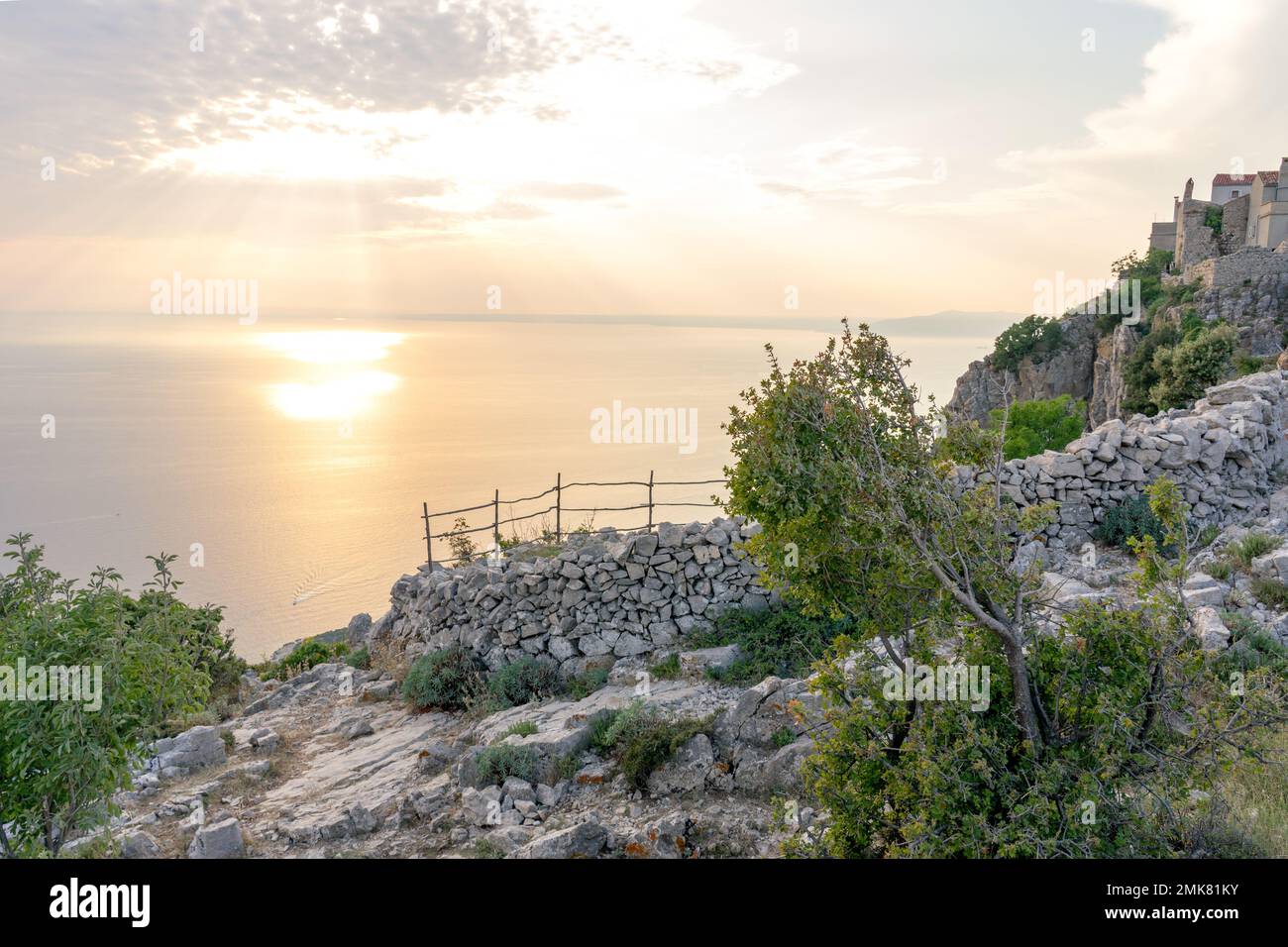The famous Lubenice village castle at sunset over the sea in Cres ...