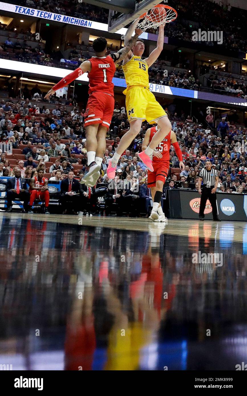 Michigan center Jon Teske, dunks over Texas Tech guard Brandone Francis ...