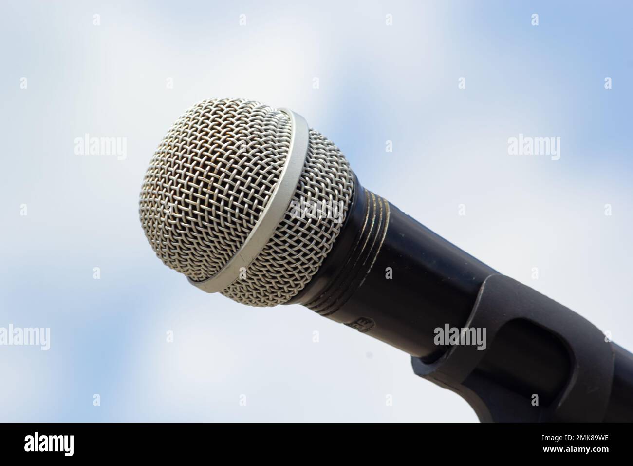 Microphone on sky background. The microphone is on the street. Concept ...