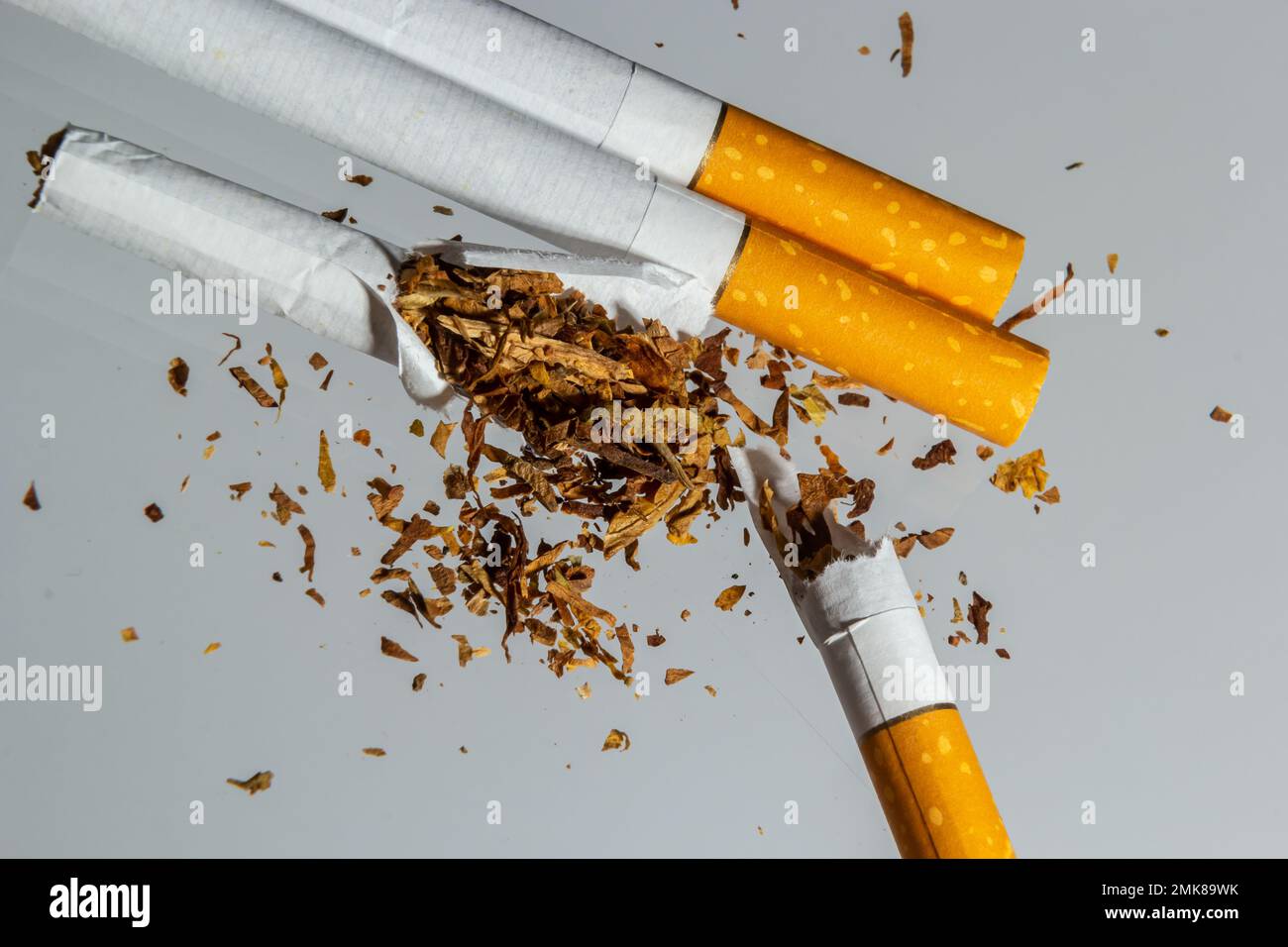 Broken cigarette fly in air on a light background. Conception of ...