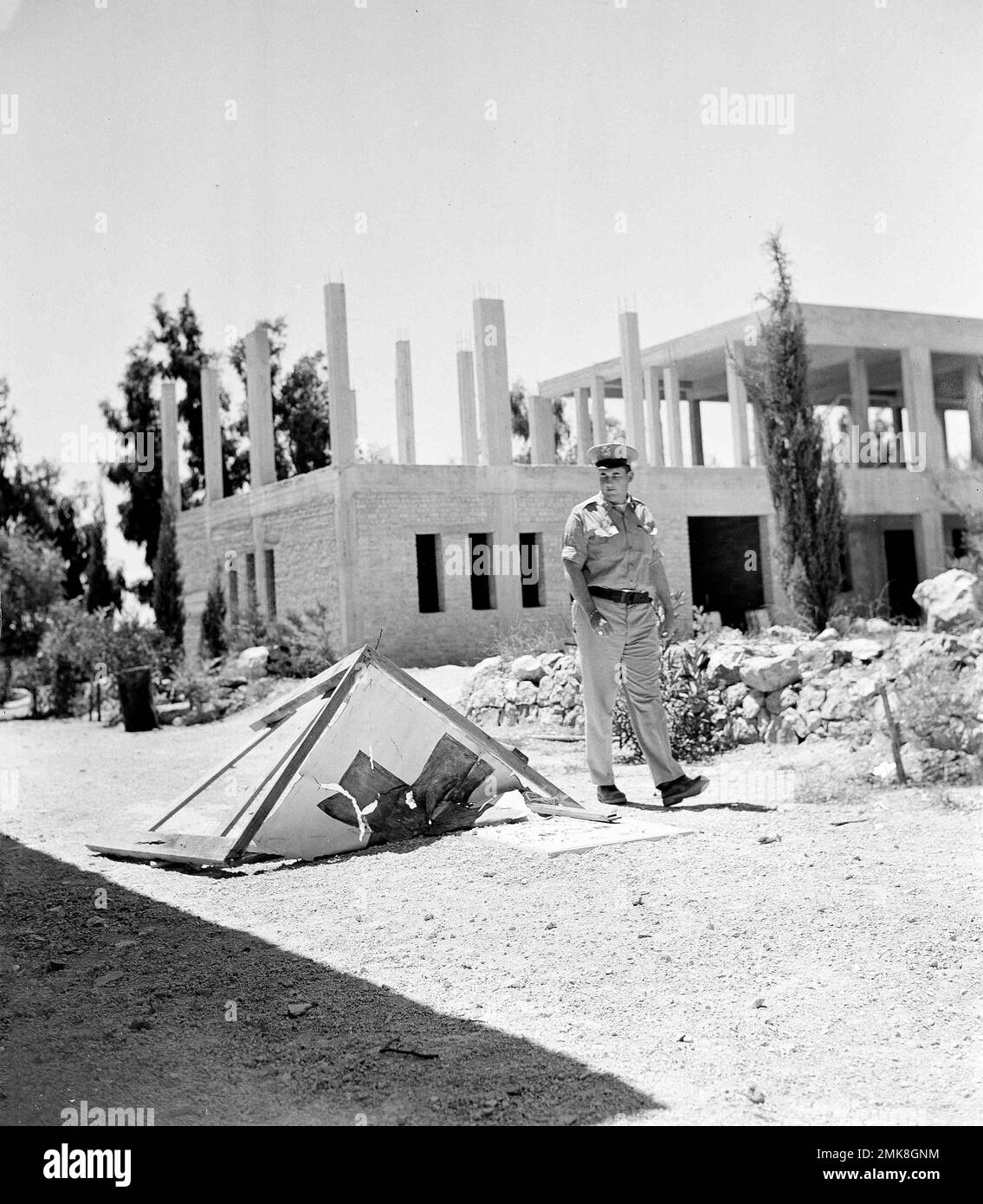 Capt. Howard Wickert walks past Red Cross sign which had been erected ...