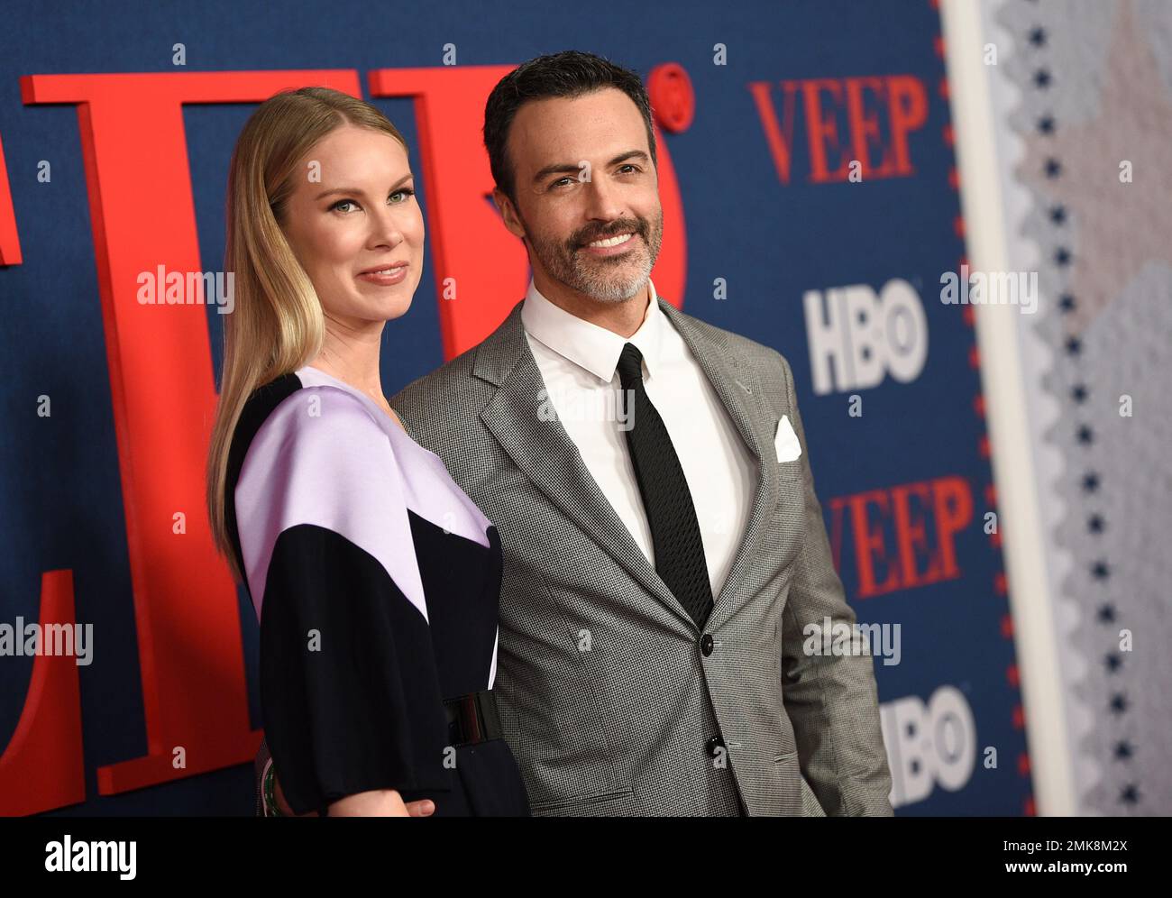 Actors Reid Scott, right, and wife Elspeth Keller attend the premiere ...