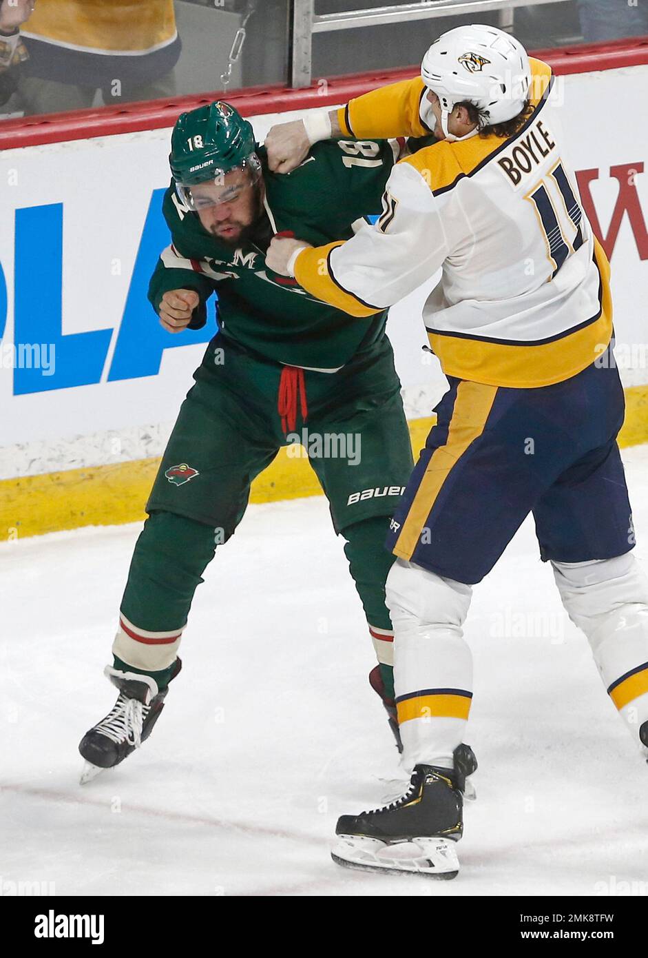 Minnesota Wild's Jordan Greenway, left, and Nashville Predators' Brian Boyle exchange punches ...