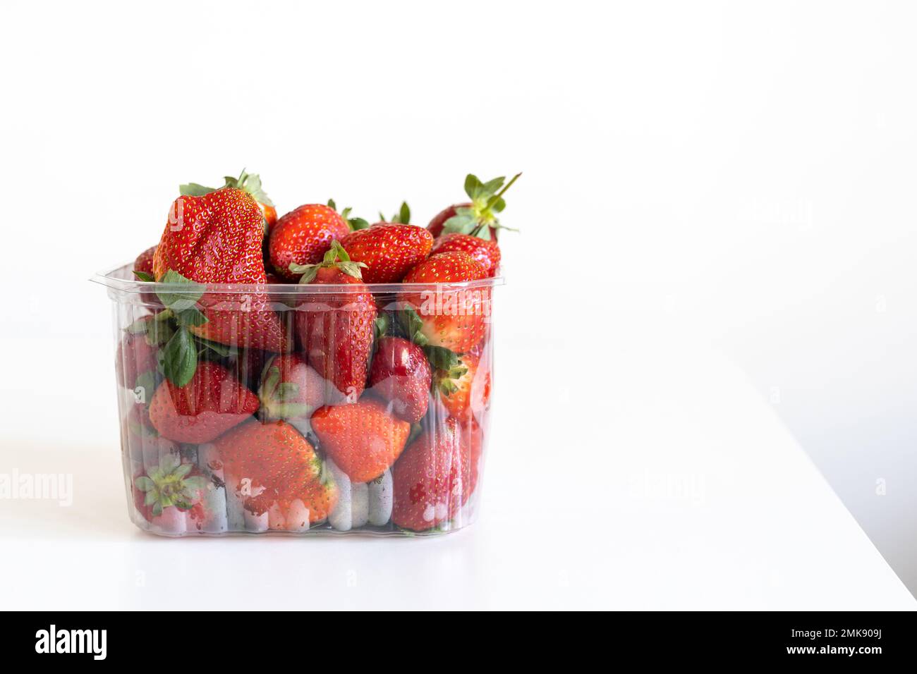 Strawberries in a plastic, foggy, container bought at the market, taken ...