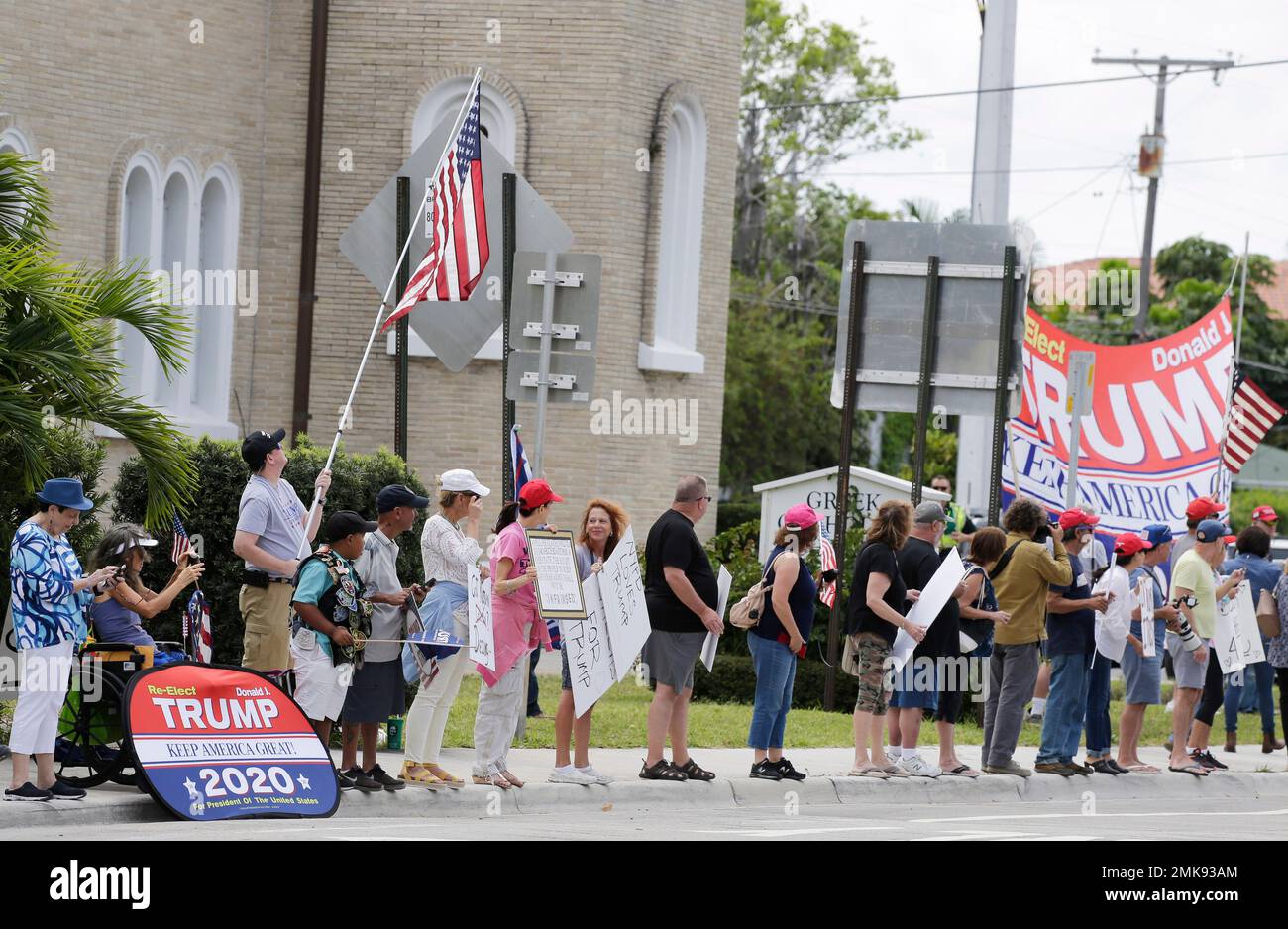 Supporters wait for the Motorcade carrying President Donald Trump ...