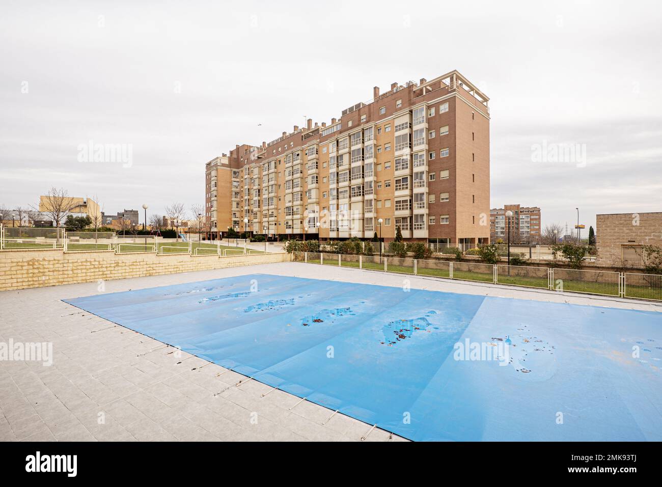 Façade of some buildings with a swimming pool complex covered with ...