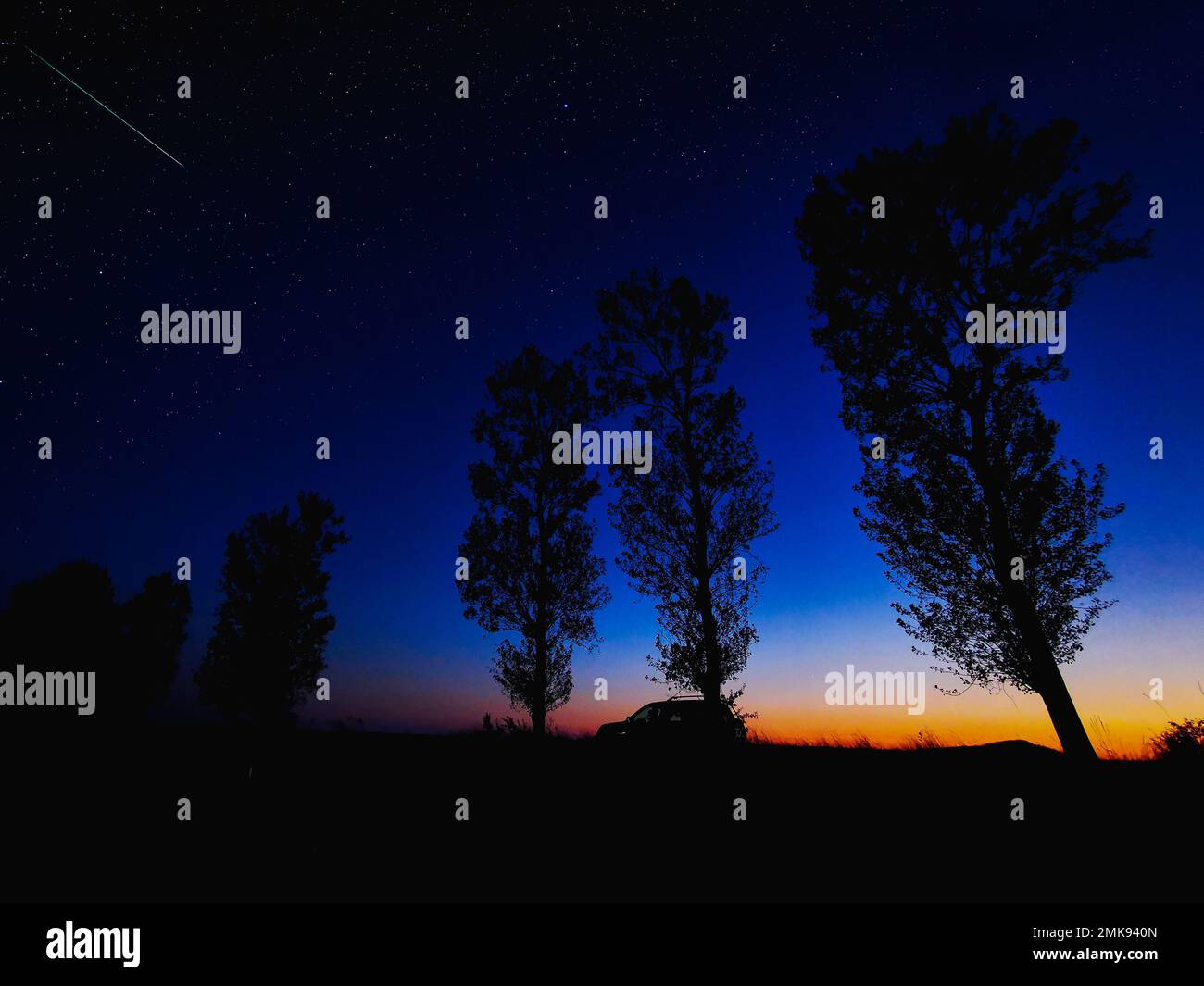 Sunset and beautiful light, car driving on the road at blue hour ...