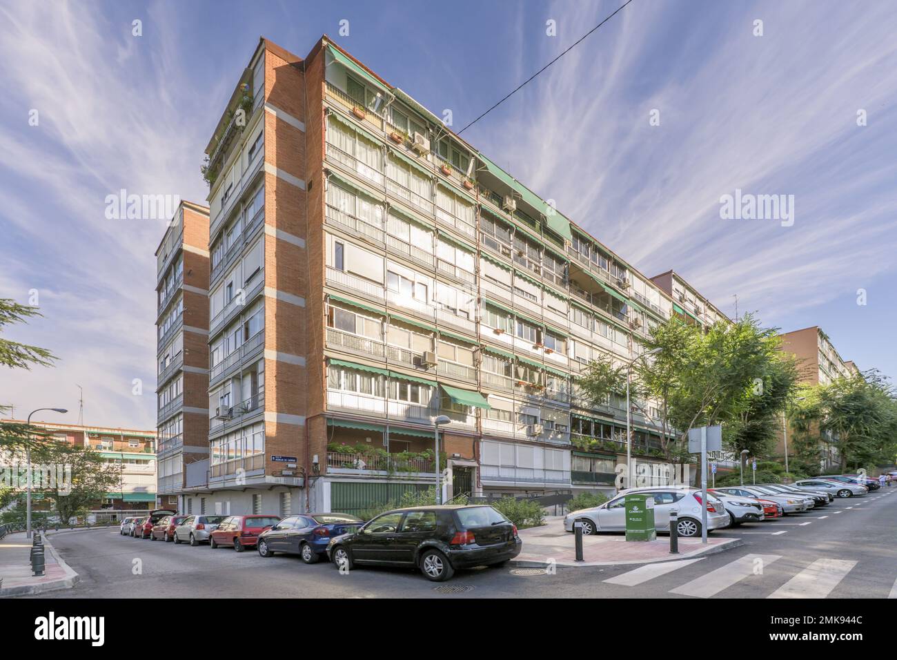 Neighborhood buildings with brick facades with parking spaces among ...