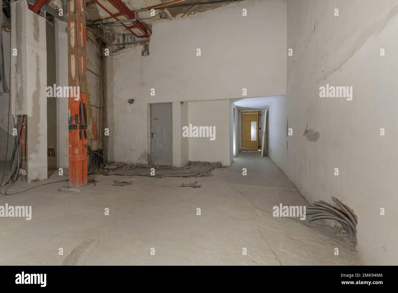 Interior premises under construction with raw cement floors and half ...