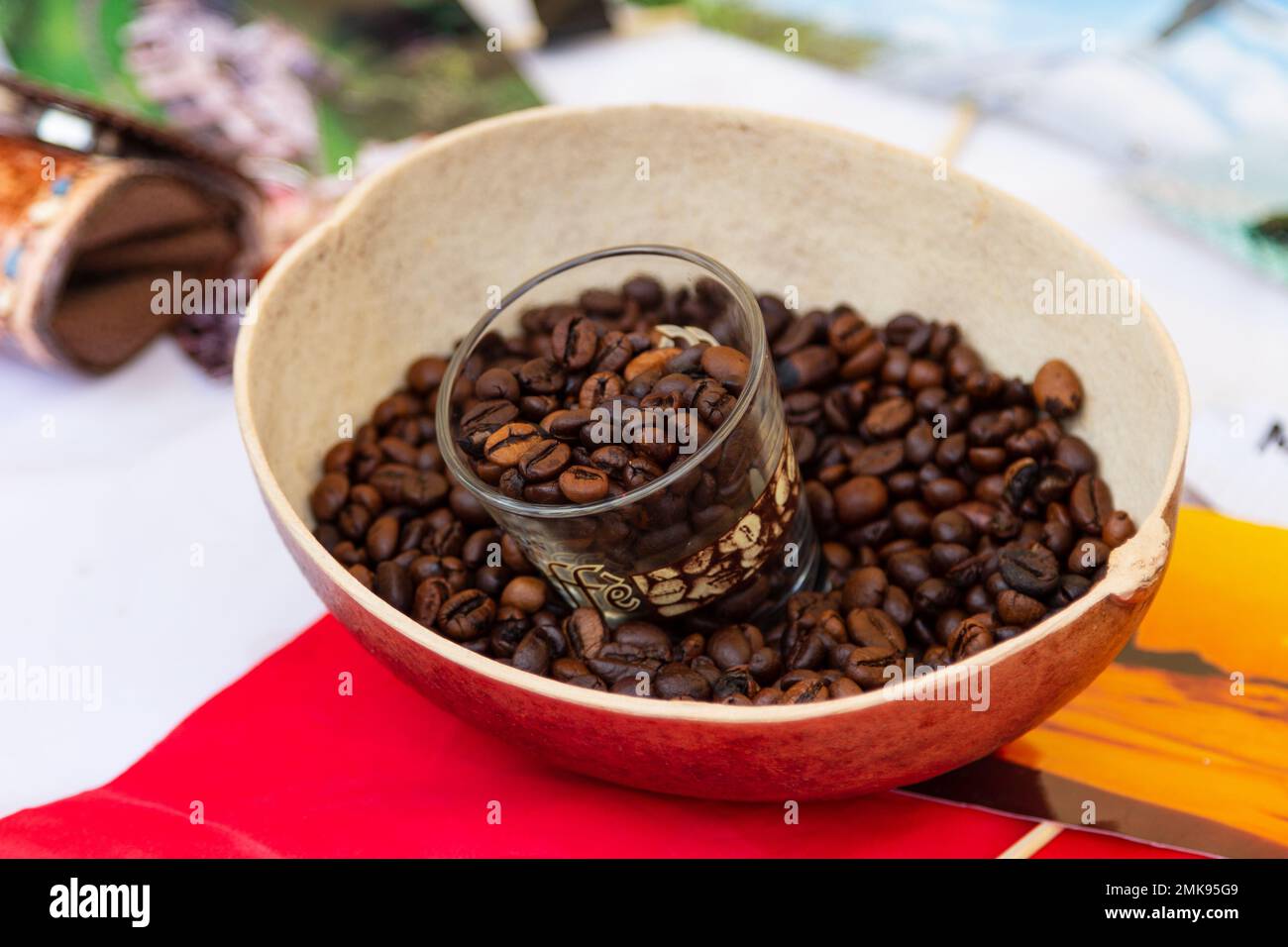 A clear glass cup filled with coffee beans, perfect for enjoying a hot ...
