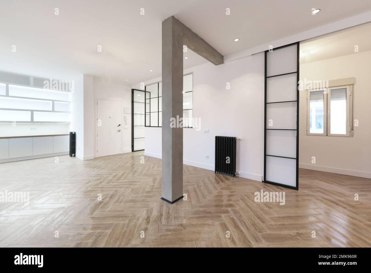 Empty house with a modern loft-style design with raw concrete beams and ...