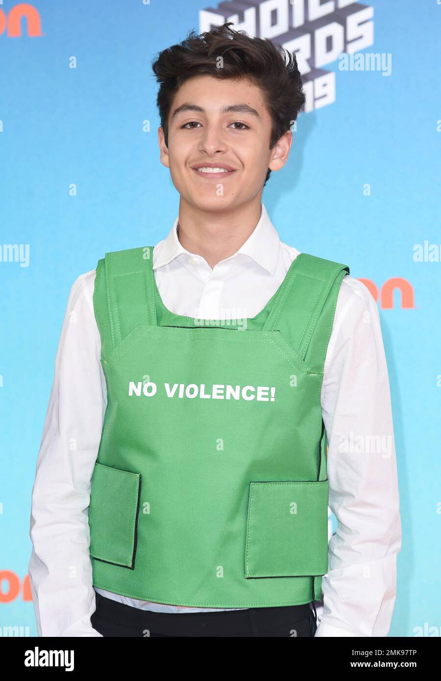 Marcel Ruiz arrives wearing a vest stating "No Violence!" at the ...