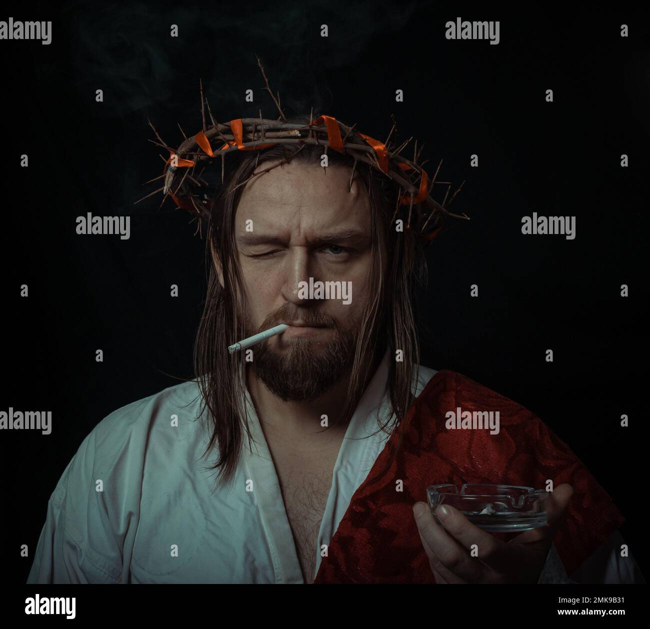 Jesus Christ smokes a cigarette wearing a crown of thorns and white ...