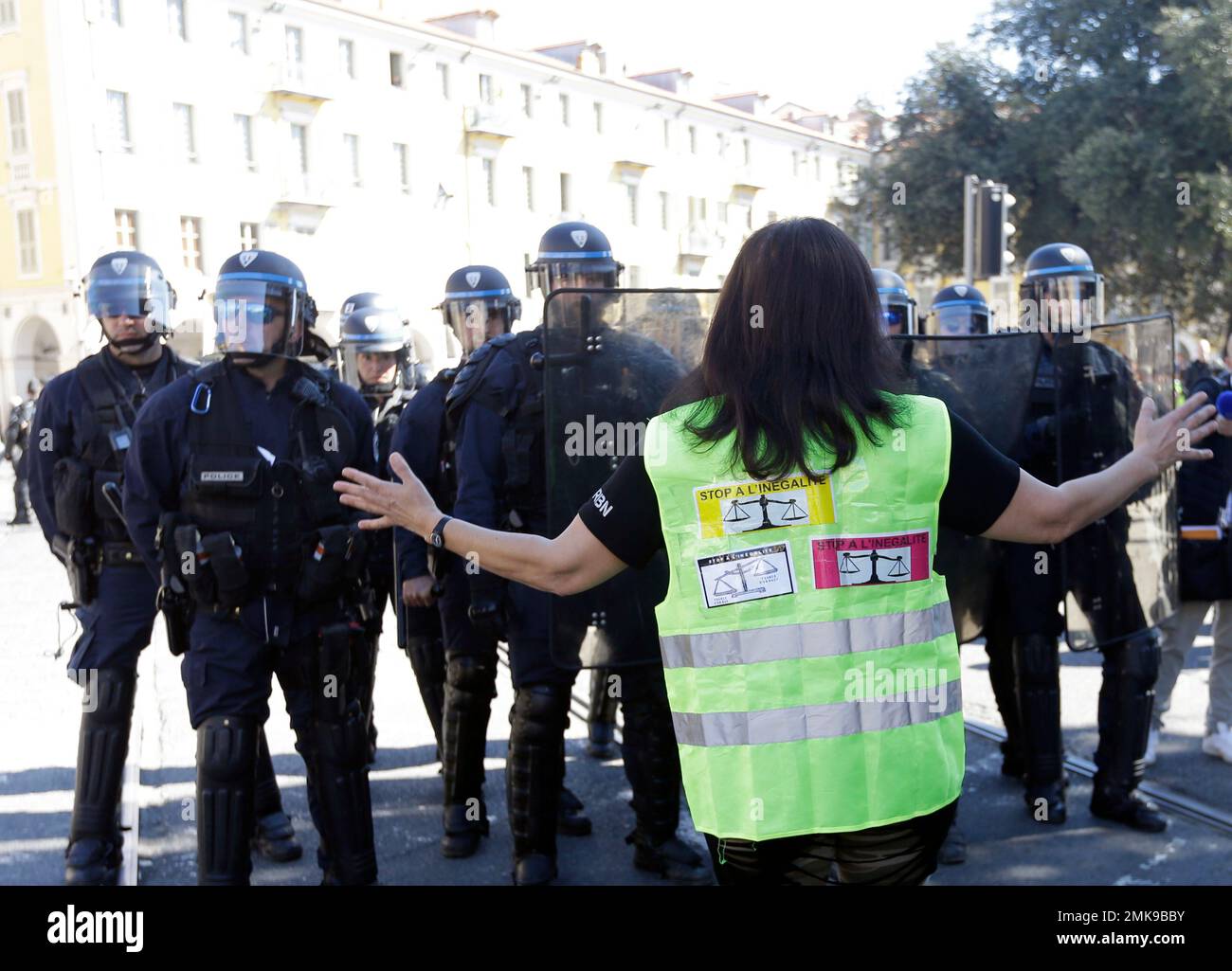 A yellow vest protester shout slogans in front of police cordon during ...