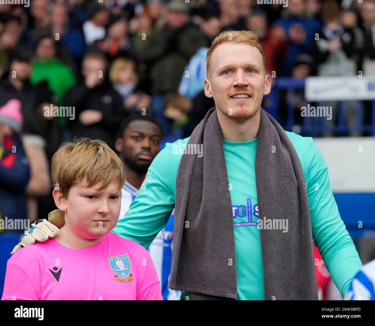 Cameron Dawson #25 of Sheffield Wednesday leads out a young mascot ...
