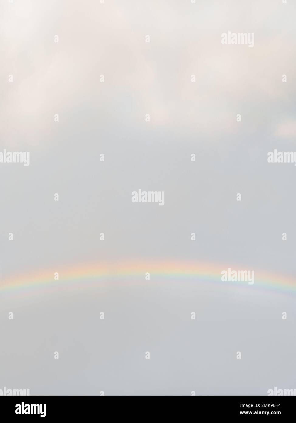 Photo of bright and colorful rainbow in the air. Cloudscape after ...