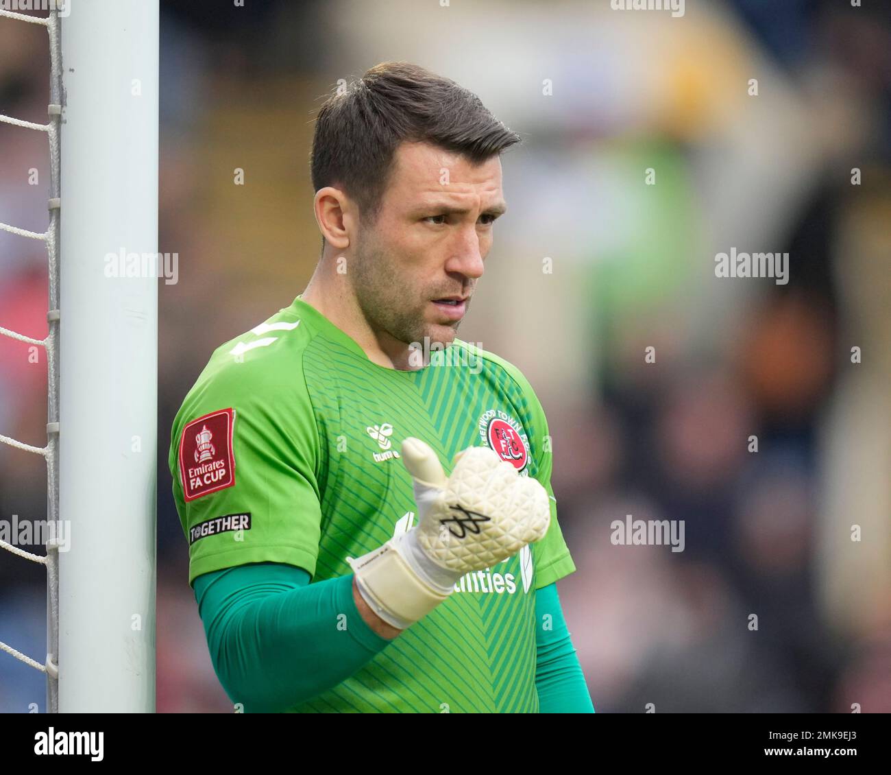Jay Lynch #13 of Fleetwood Town passes instructions to his wall during ...
