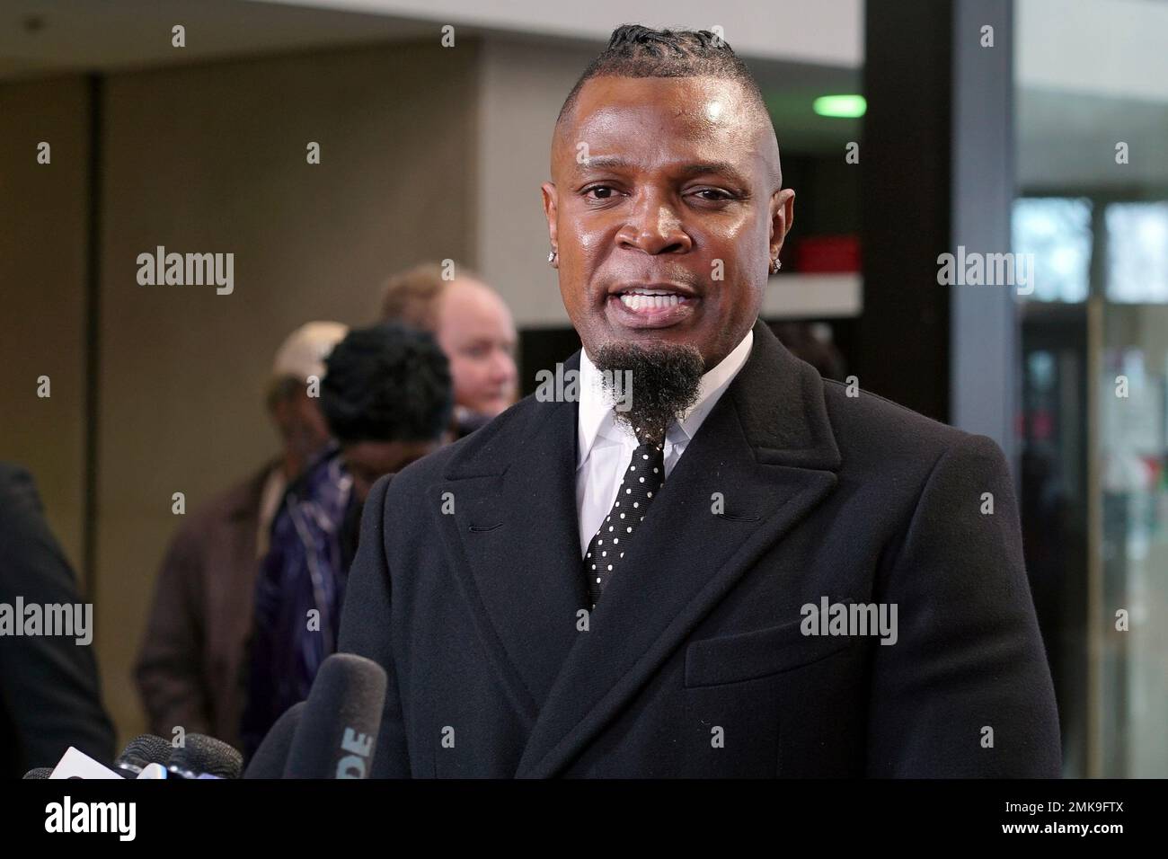 Darryll Johnson, publicist for singer R. Kelly, speaks to the media ...