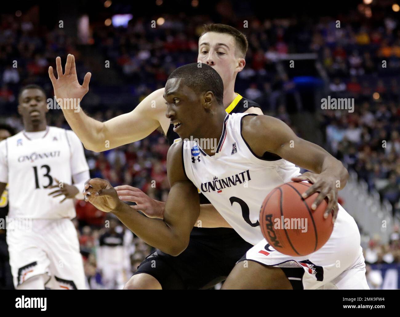 Cincinnati's Keith Williams (2) drives past Iowa's Joe Wieskamp (10) in ...