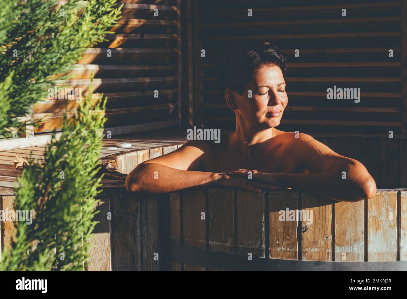 Woman relaxing in outdoor spa hi-res stock photography and images - Alamy