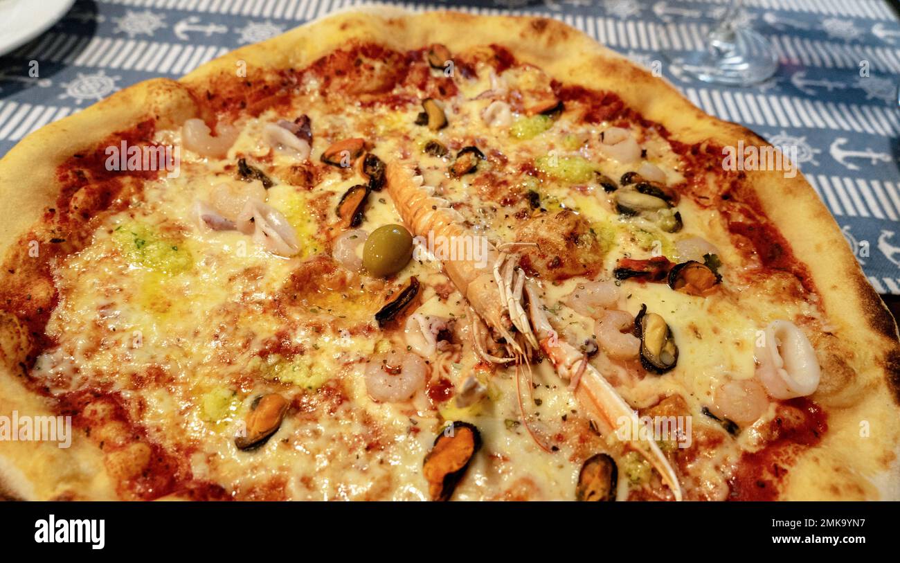 eating seafood frutti di mare pizza in a seafood restaurant in Croatia ...