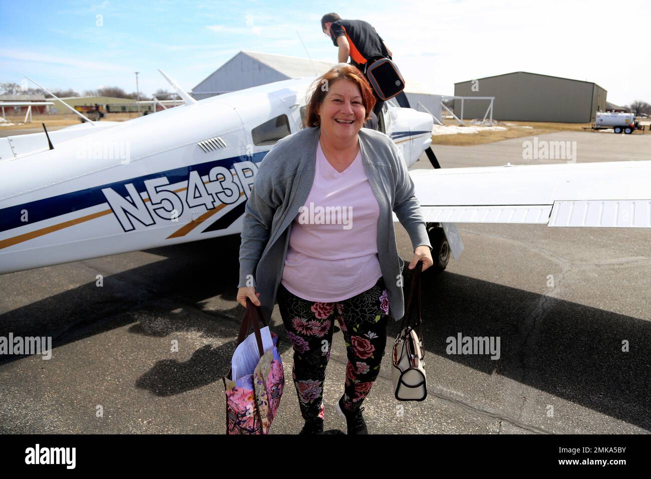 Connie Hamilton gets off a volunteer aircraft that brought her back ...
