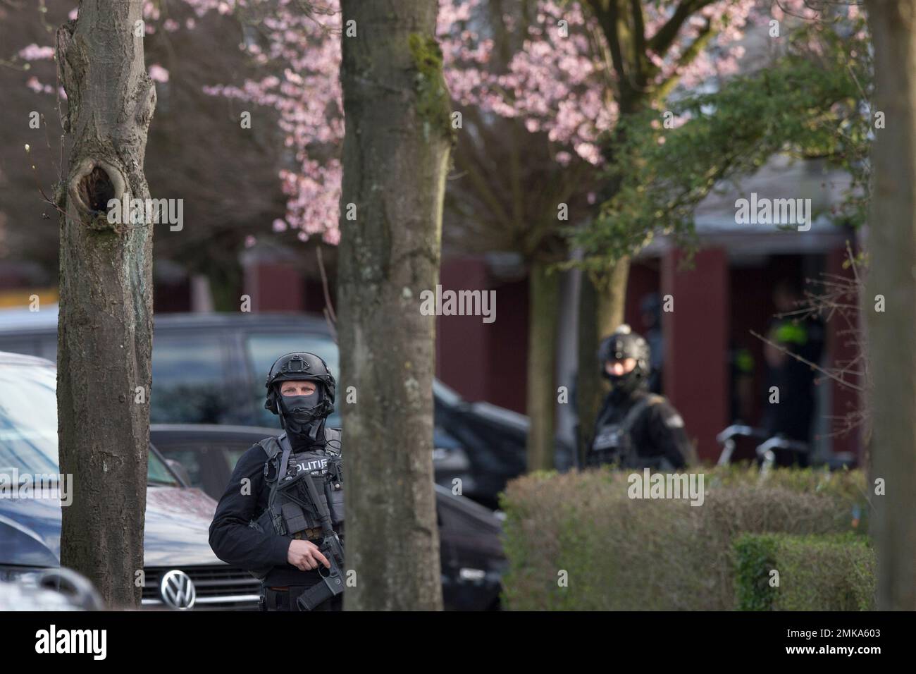 Dutch counter terrorism police stand guard as others enter a house ...