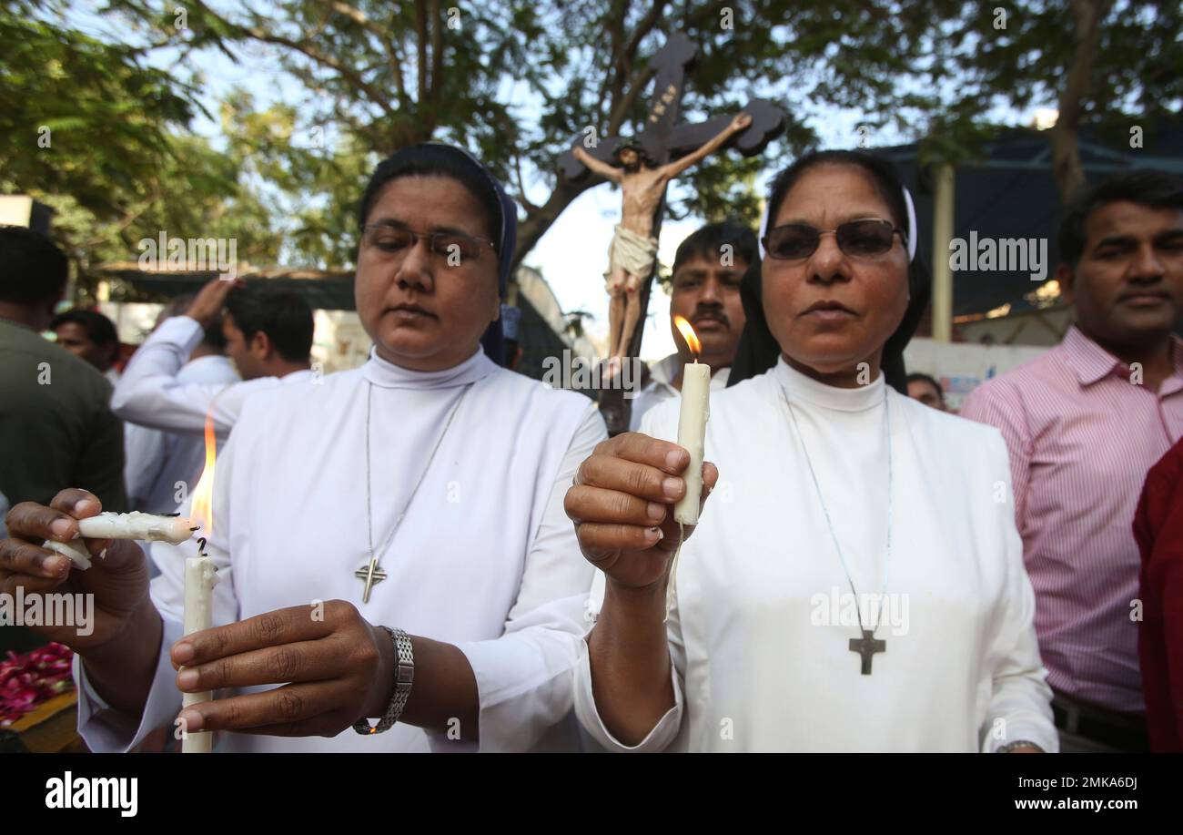 Pakistani nuns hold candles during a vigil for the victims of the ...