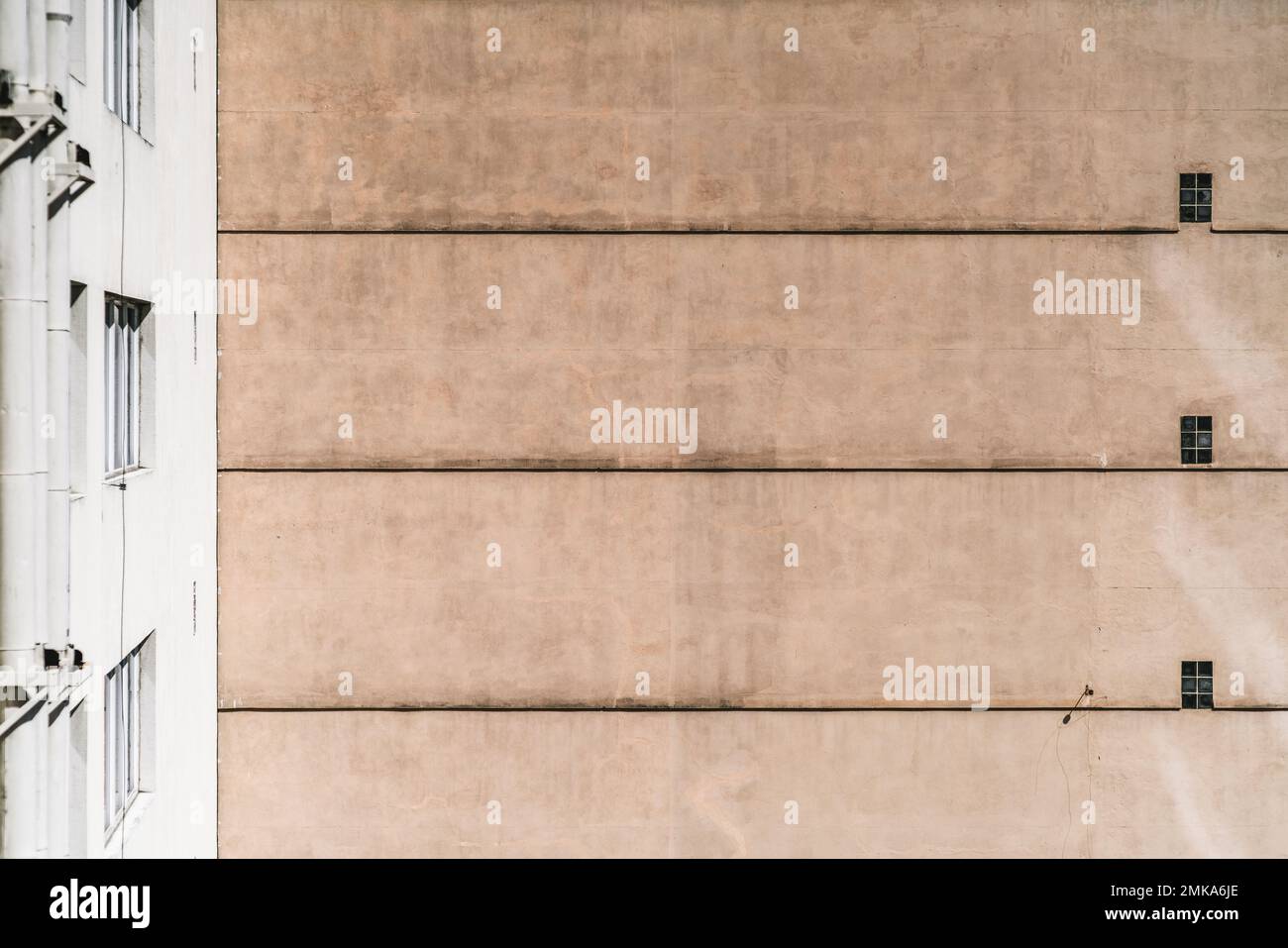 View of a plastered building elevation wall with a pattern of floor ...