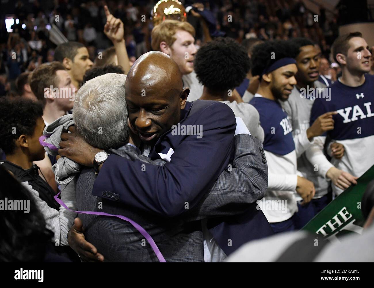 Yale head coach James Jones embraces Yales President Peter Salovey ...