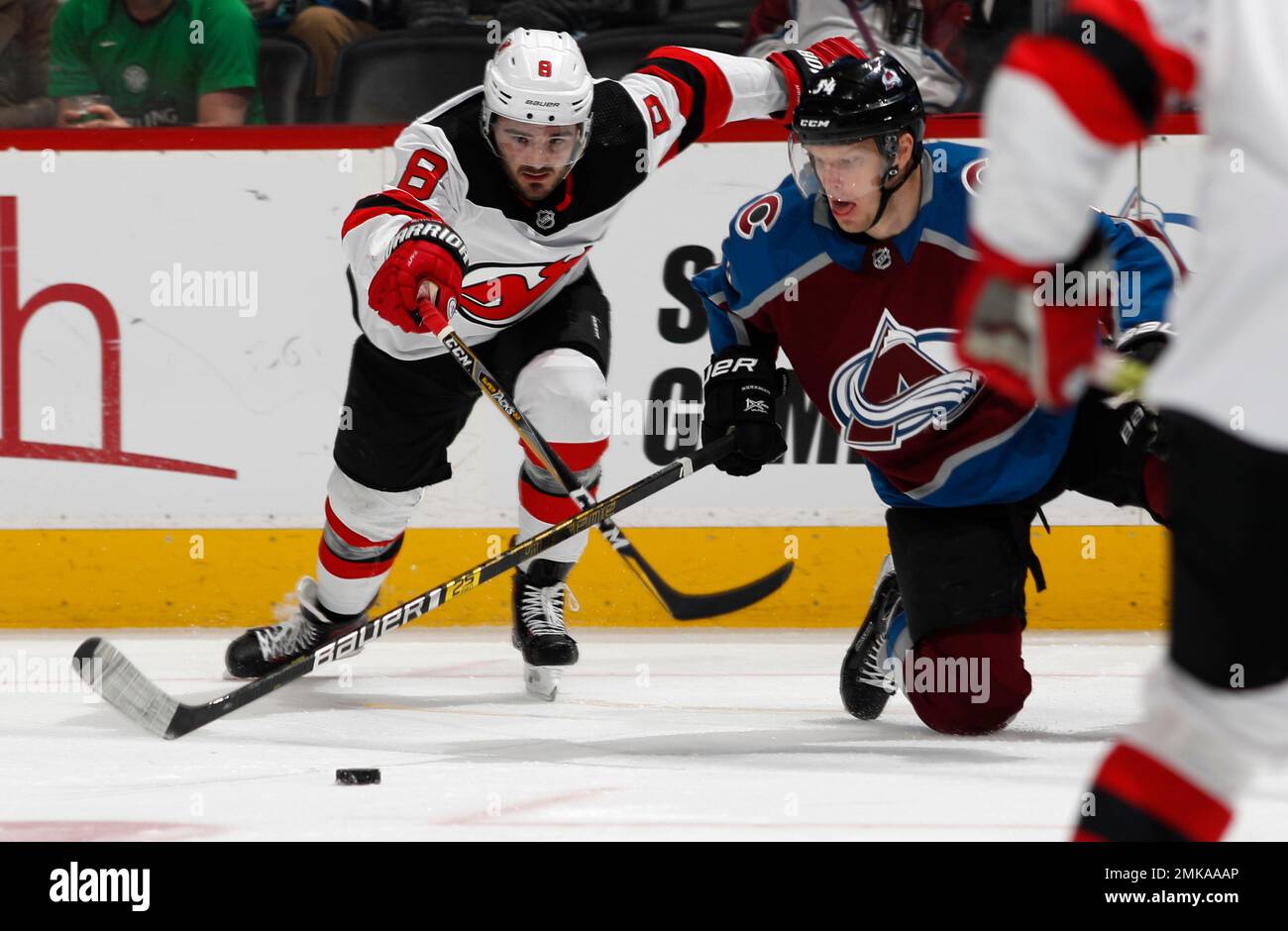 New Jersey Devils defenseman Will Butcher, left, pursues a loose puck ...