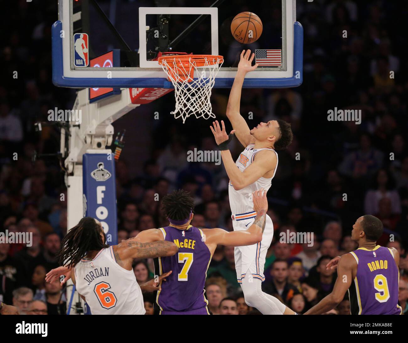 New York Knicks' Kevin Knox, top, scores during the first half of an ...