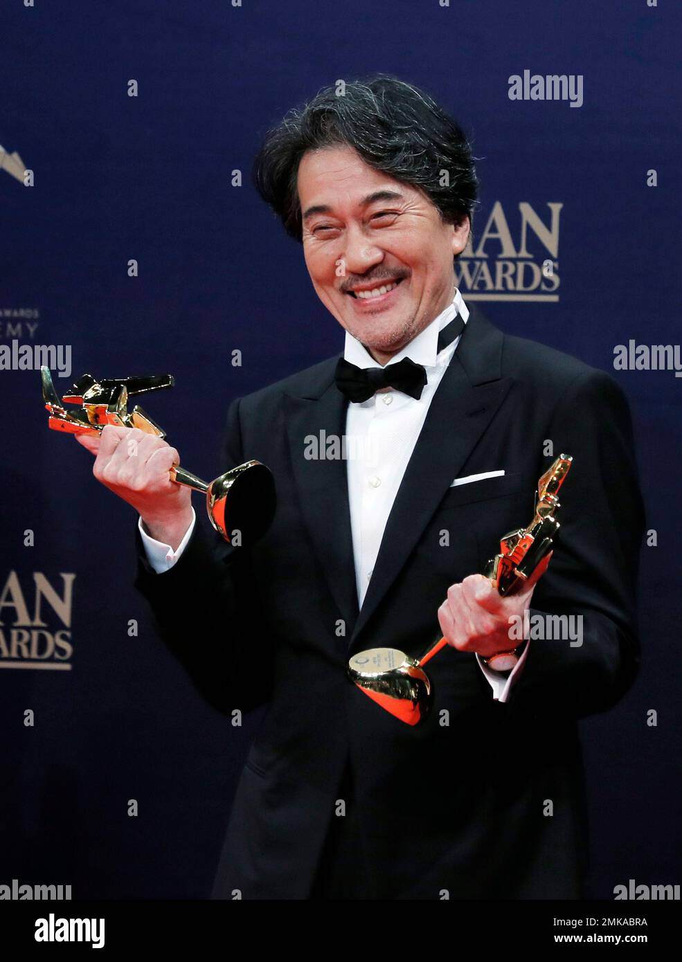 Japanese actor Koji Yakusho poses after winning the Best Actor and ...