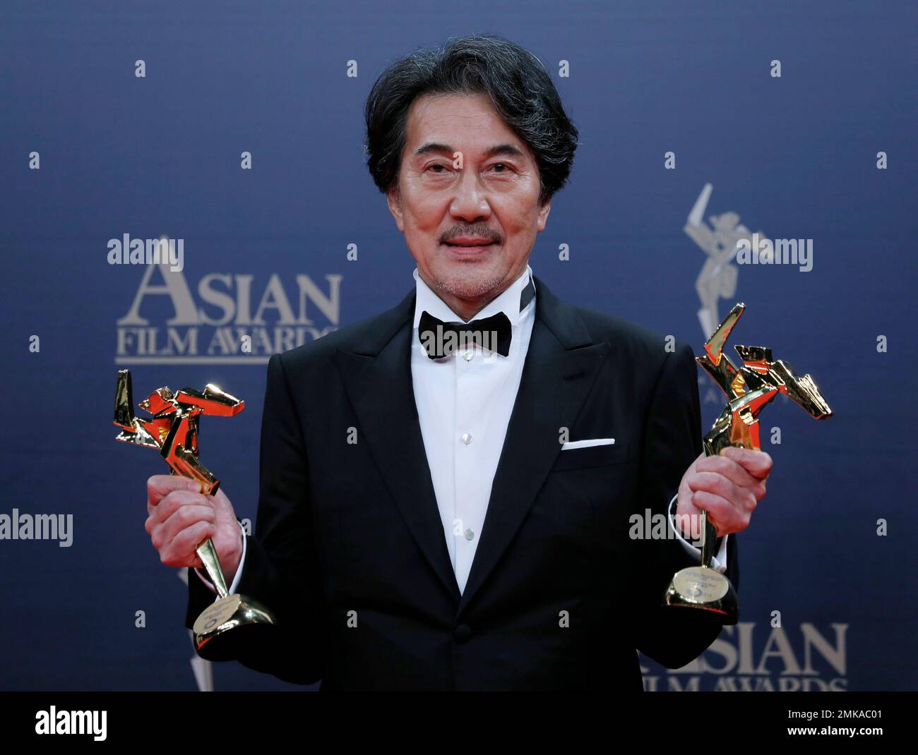 Japanese actor Koji Yakusho poses after winning the Best Actor and ...