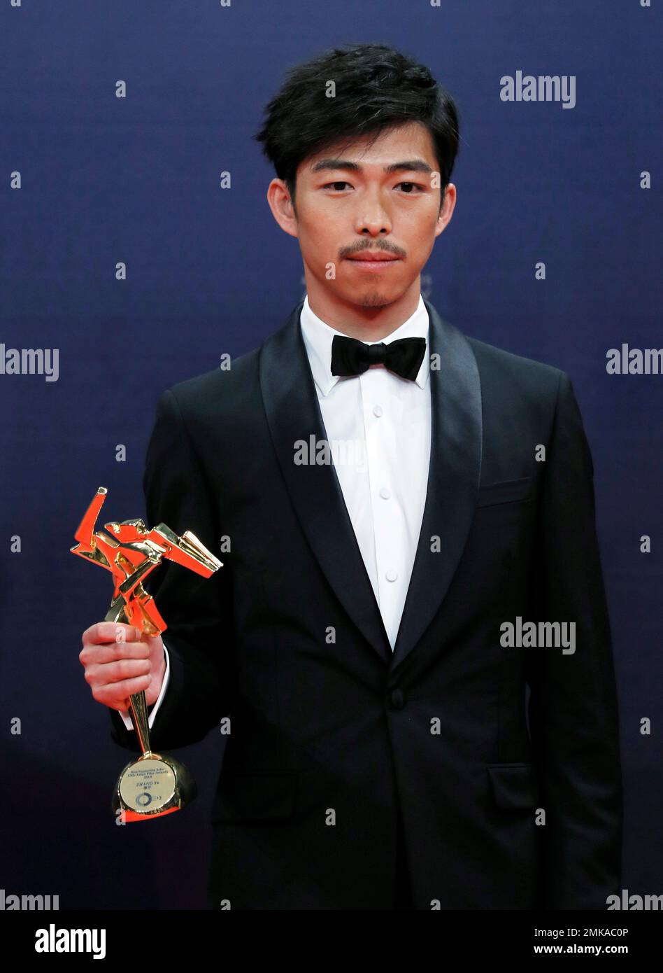 Chinese actor Zhang Yu poses after winning the Best Supporting Actor ...