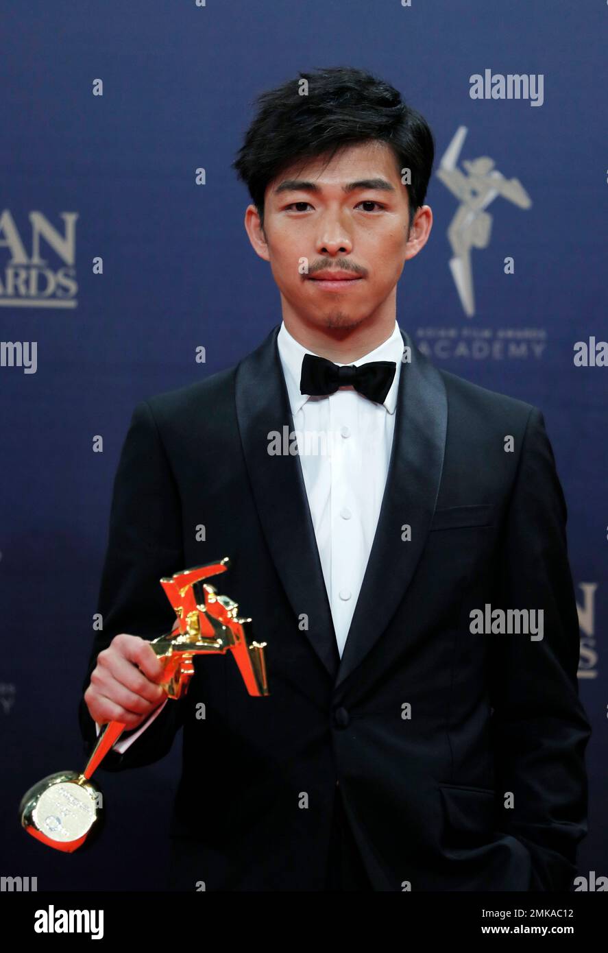 Chinese actor Zhang Yu poses after winning the Best Supporting Actor ...