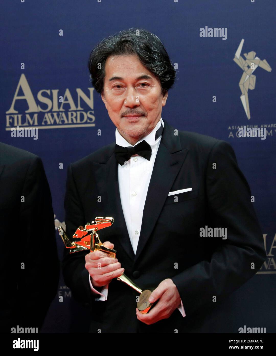 Japanese actor Koji Yakusho poses after winning the Excellence in Asian ...