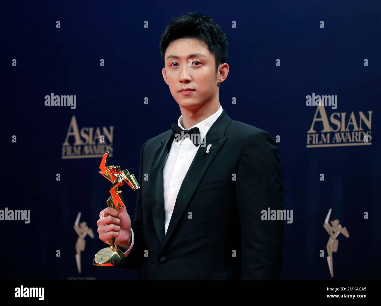 Chinese actor Johnny Huang Jinyu poses after winning the Best Newcomer ...