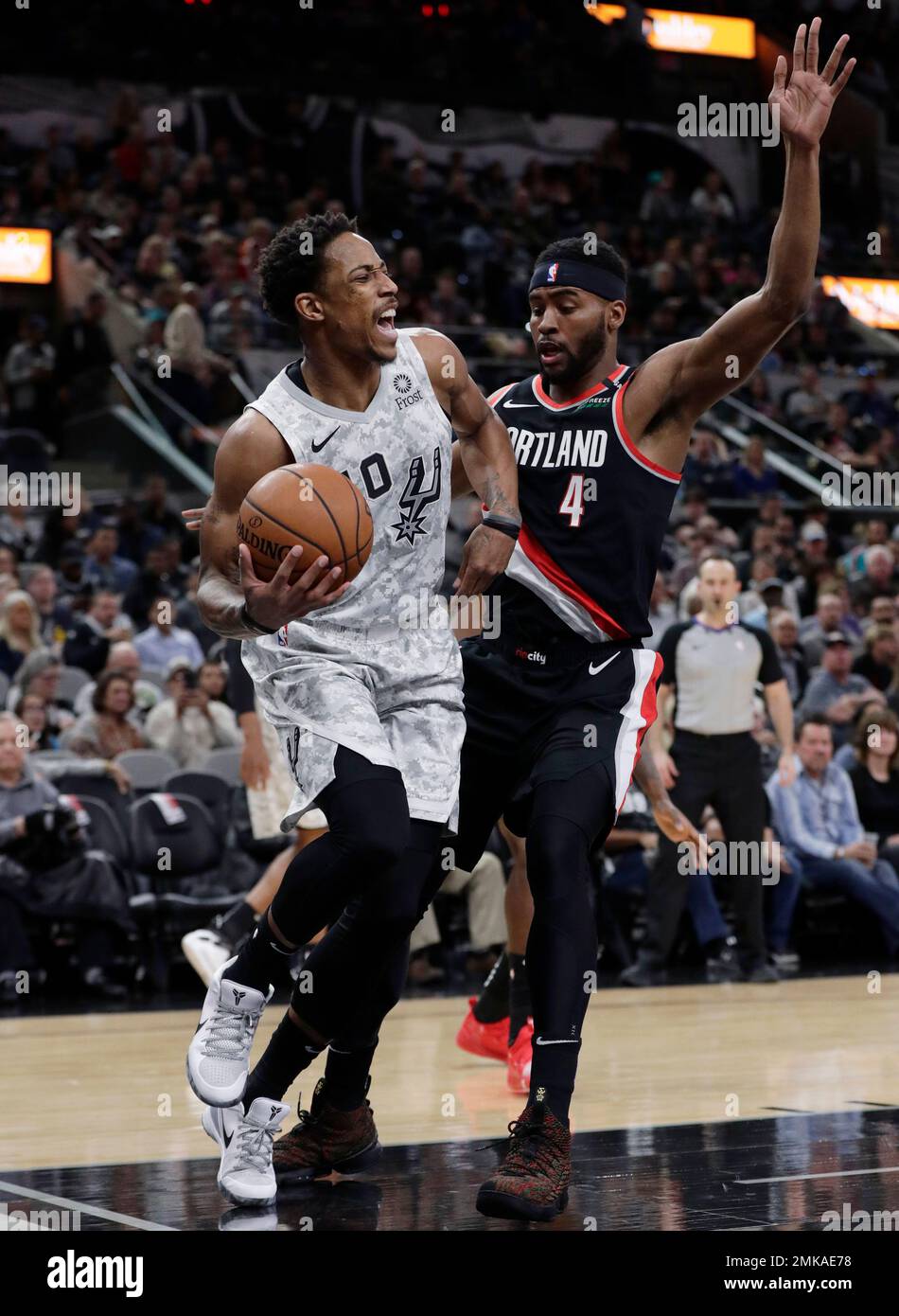 San Antonio Spurs guard DeMar DeRozan (10) drives around Portland Trail ...