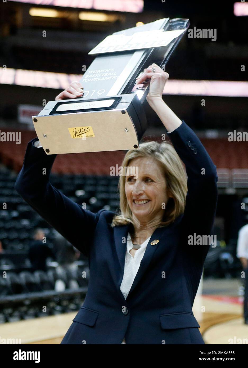 UC Davis coach Jennifer Gross holds up the trophy after the team ...