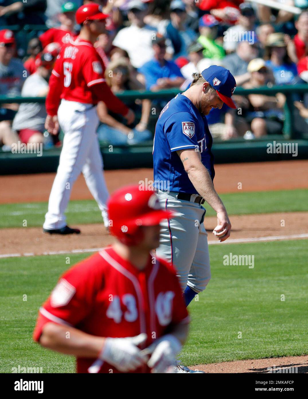 Texas Rangers pitcher Shelby Miller looks down after walking Cincinnati ...