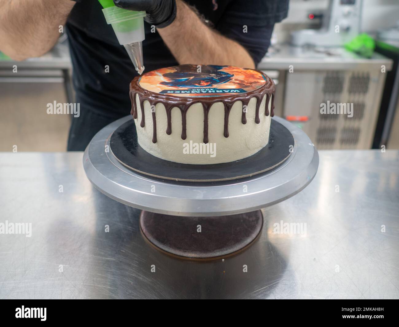 cake pastry chef designer decoration a dark chocolate frosted icing ...