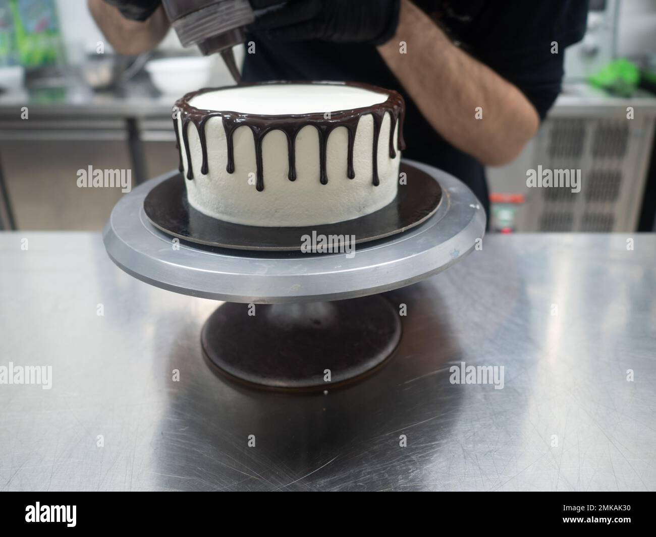 cake pastry chef designer decoration a dark chocolate frosted icing ...