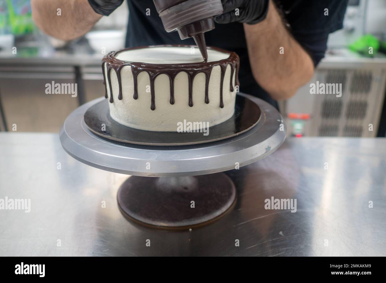 cake pastry chef designer decoration a dark chocolate frosted icing ...