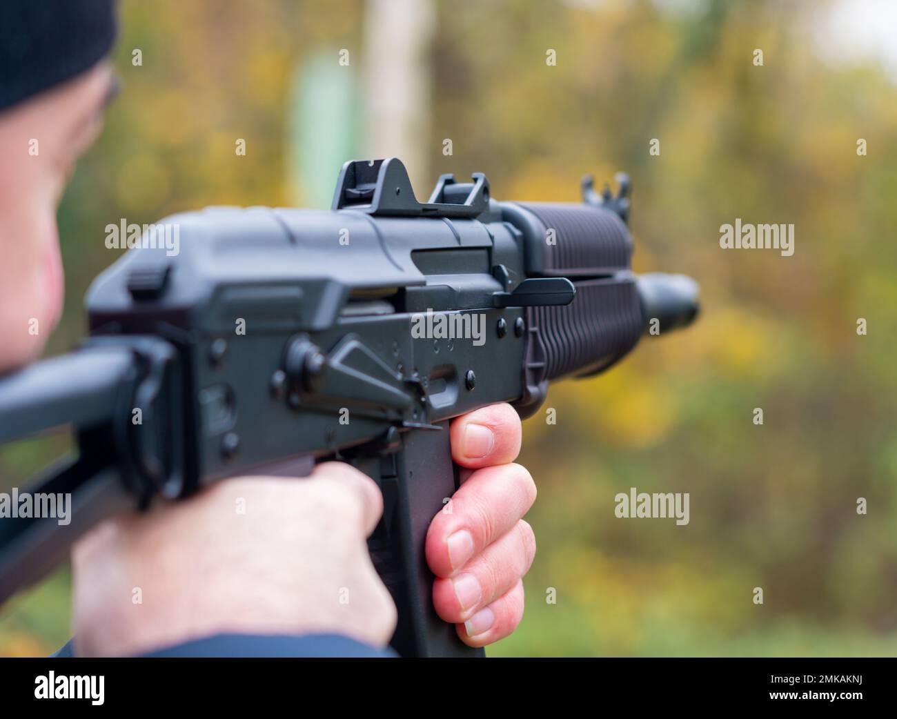 A man takes aim from an assault rifle in the first person against the ...