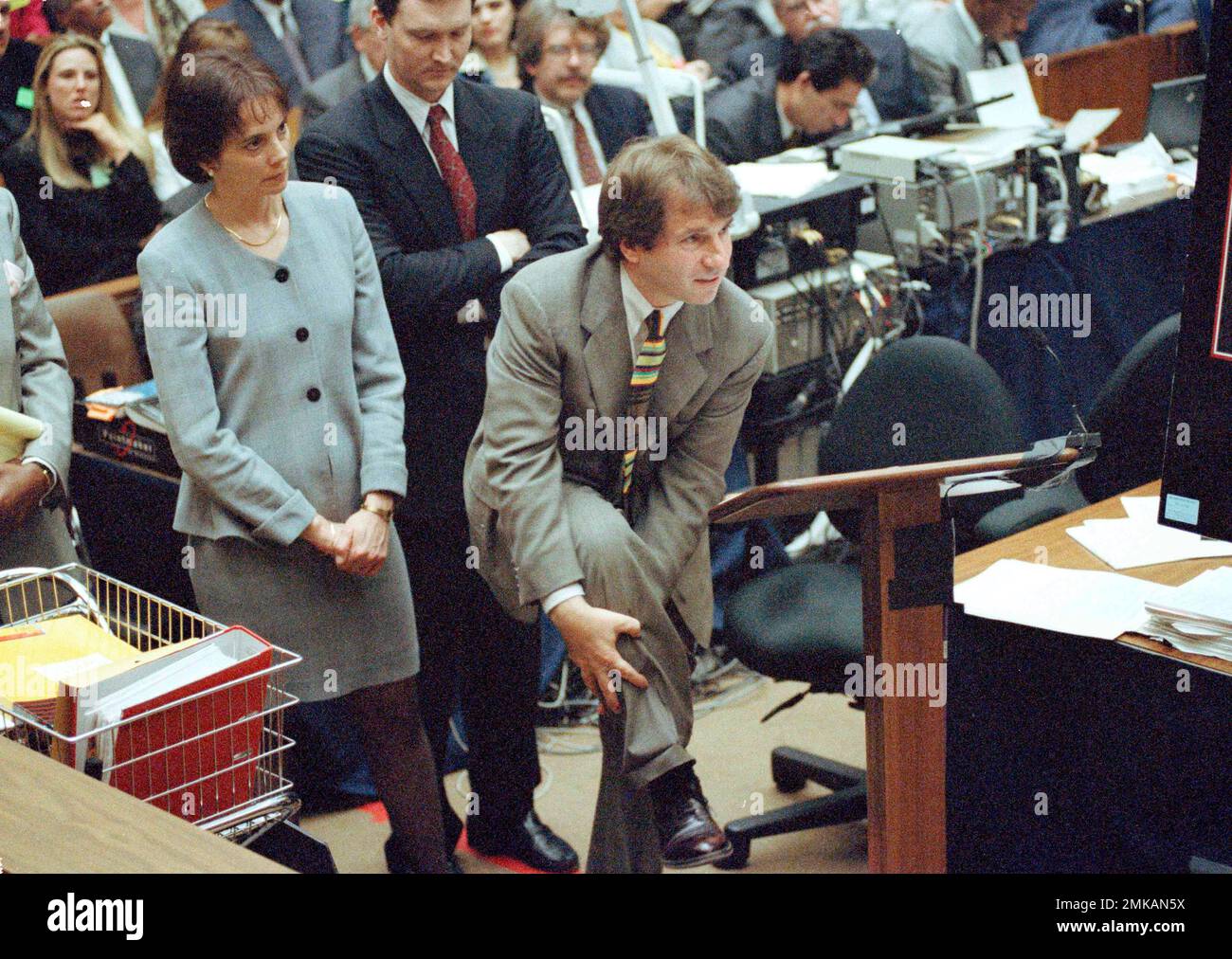 O.J. Simpson defense attorney Barry Scheck, right, grabs his leg while ...