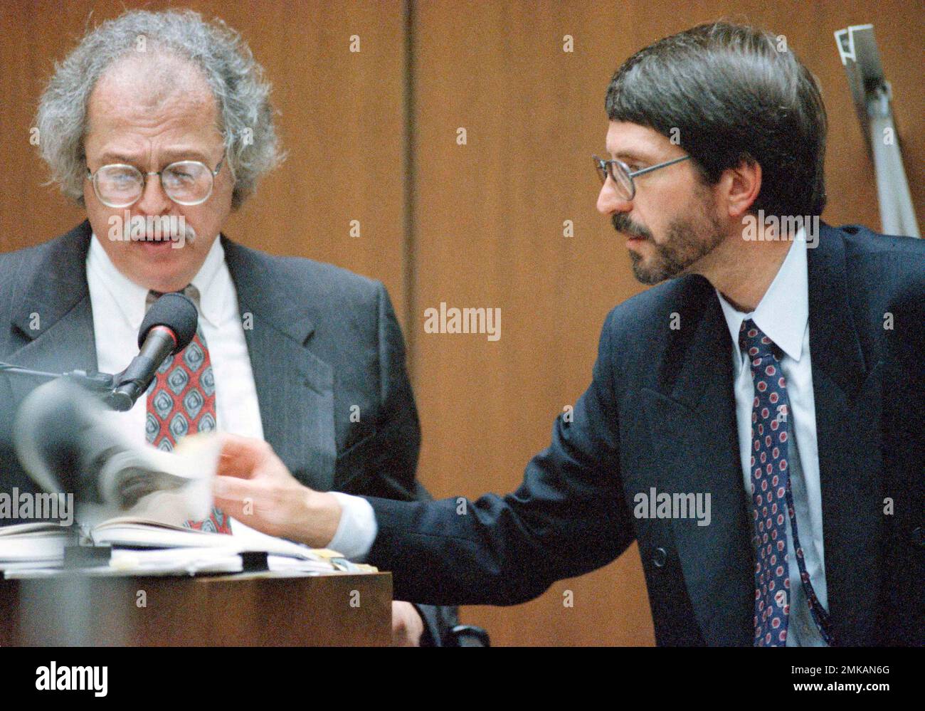 Prosecuting attorney Brian Kelberg, right, shows photos of the murder ...
