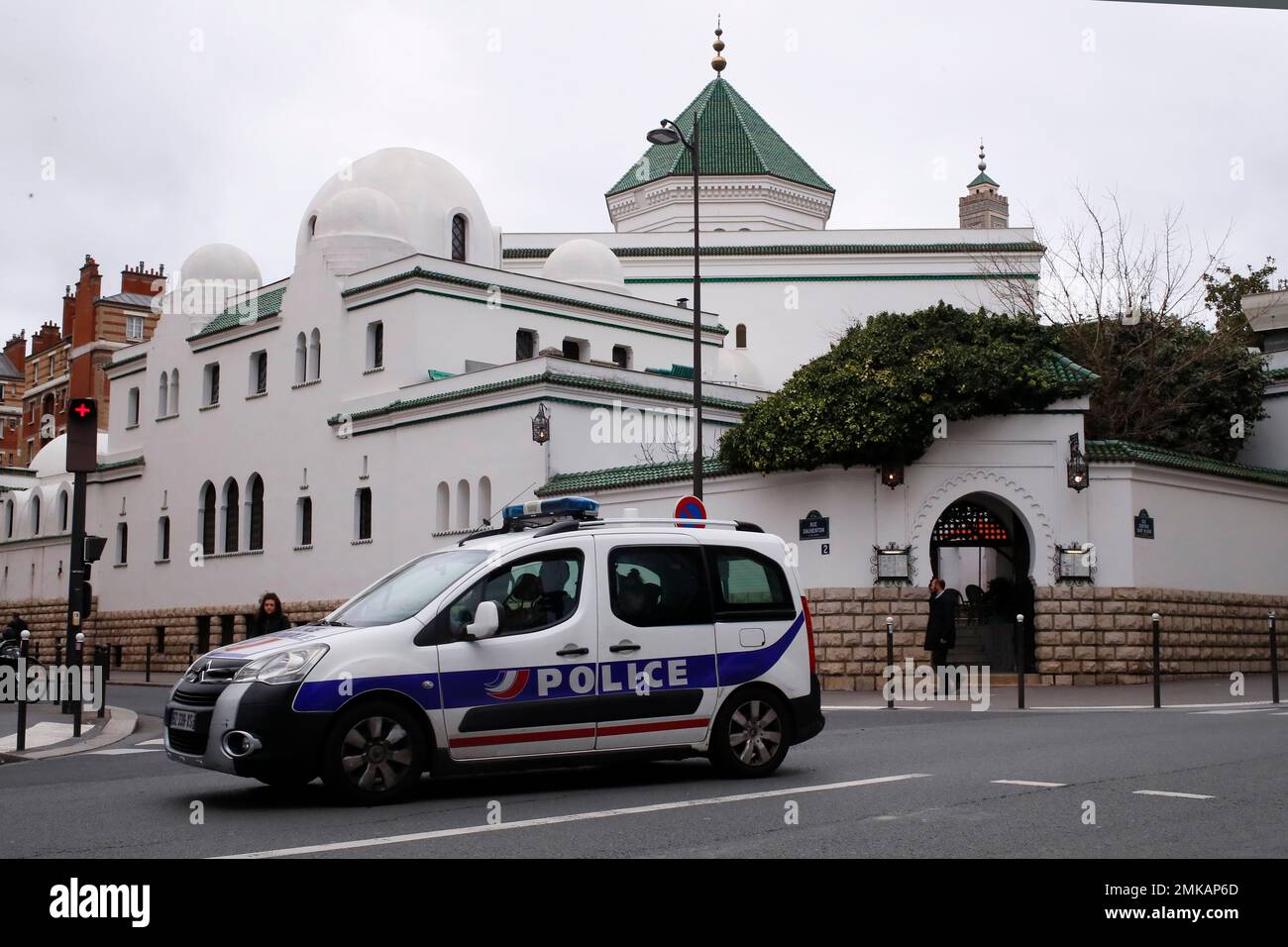 A police car drives past the Grand Mosque in Paris, Friday, March 15 ...