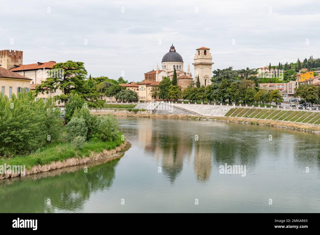 Looking up a calm Fiume Adige river towards the Saint Giorgio church ...