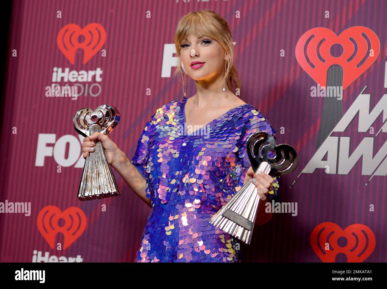 Taylor Swift poses in the press room with the awards for tour of the ...